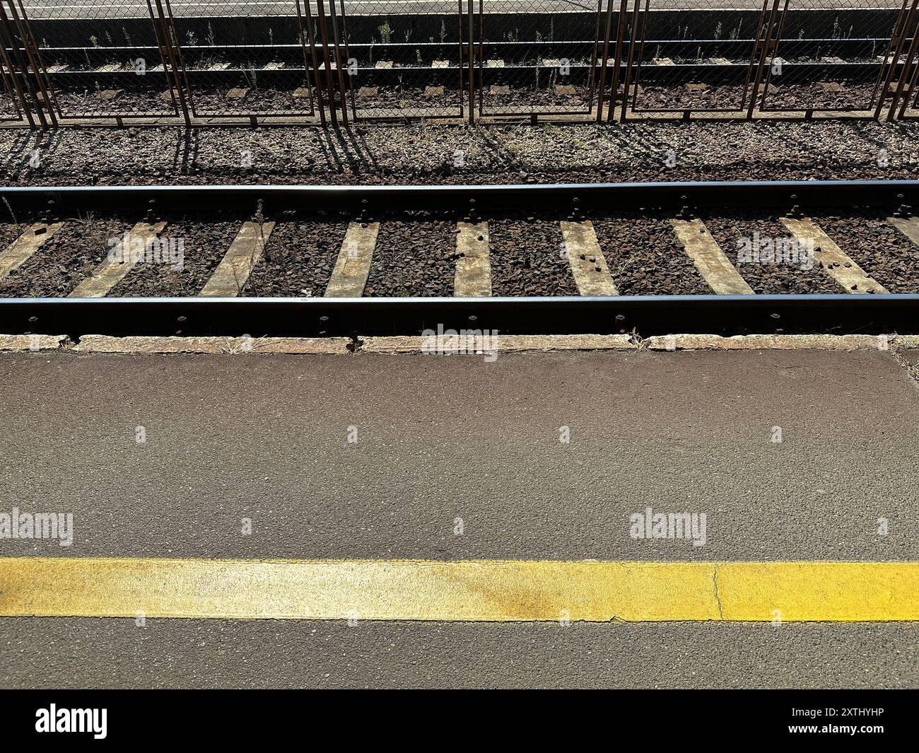 Railway station platform with yellow stripe Stock Photo - Alamy
