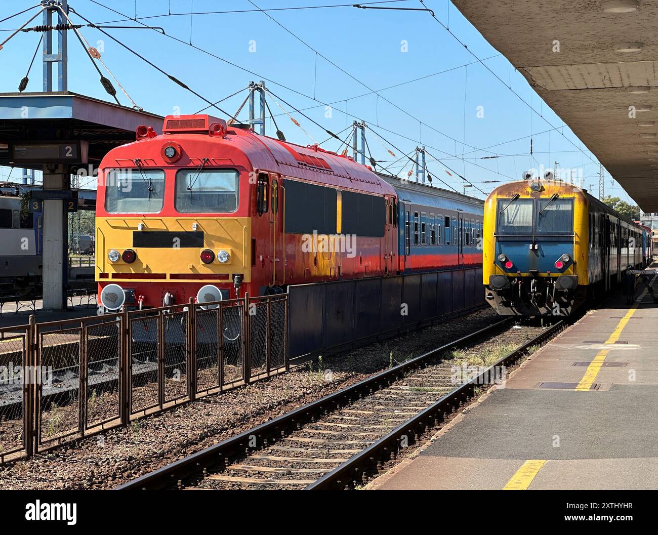 Passenger trains at the station platform Stock Photo - Alamy