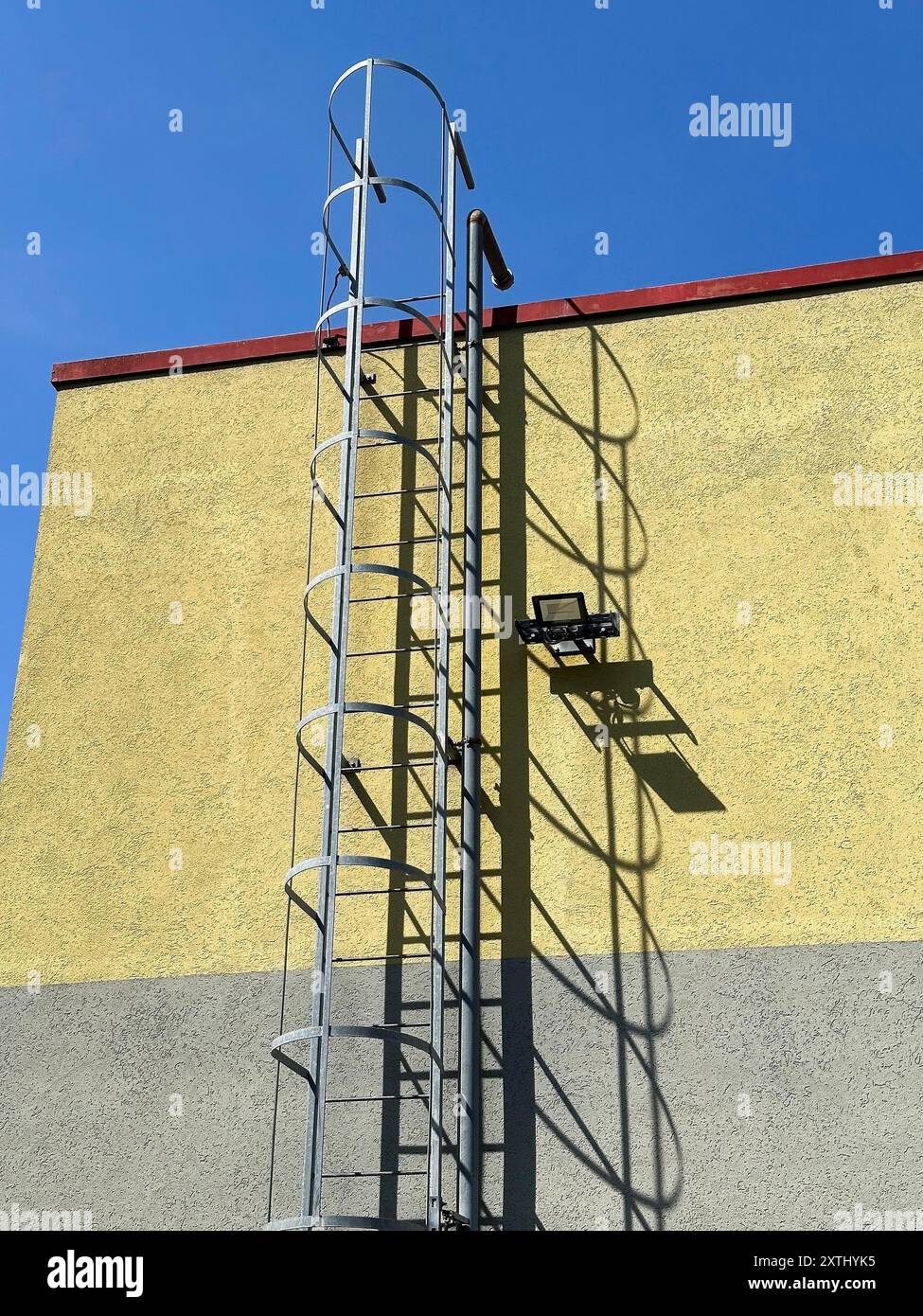 Ladder on the wall of the warehouse building Stock Photo - Alamy