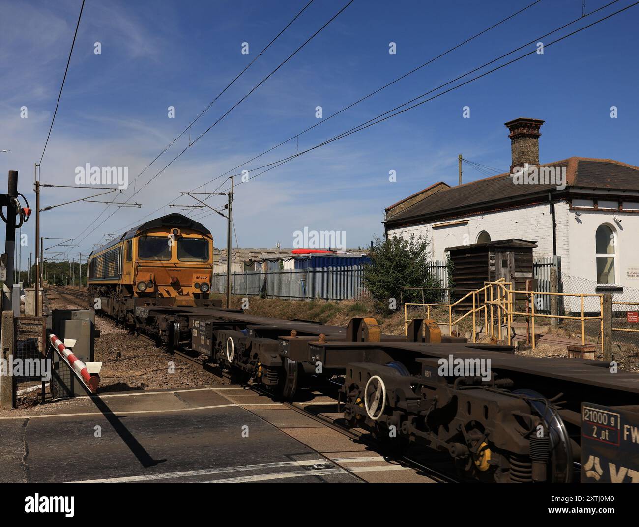 GBRF diesel locomotive no 66742 passes over the level crossing and ...