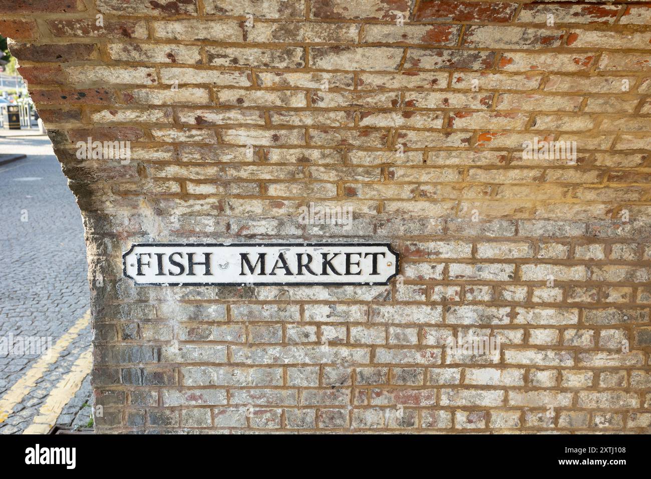 A FISH MARKET sign on the old historic cobble streets of the harbour ...