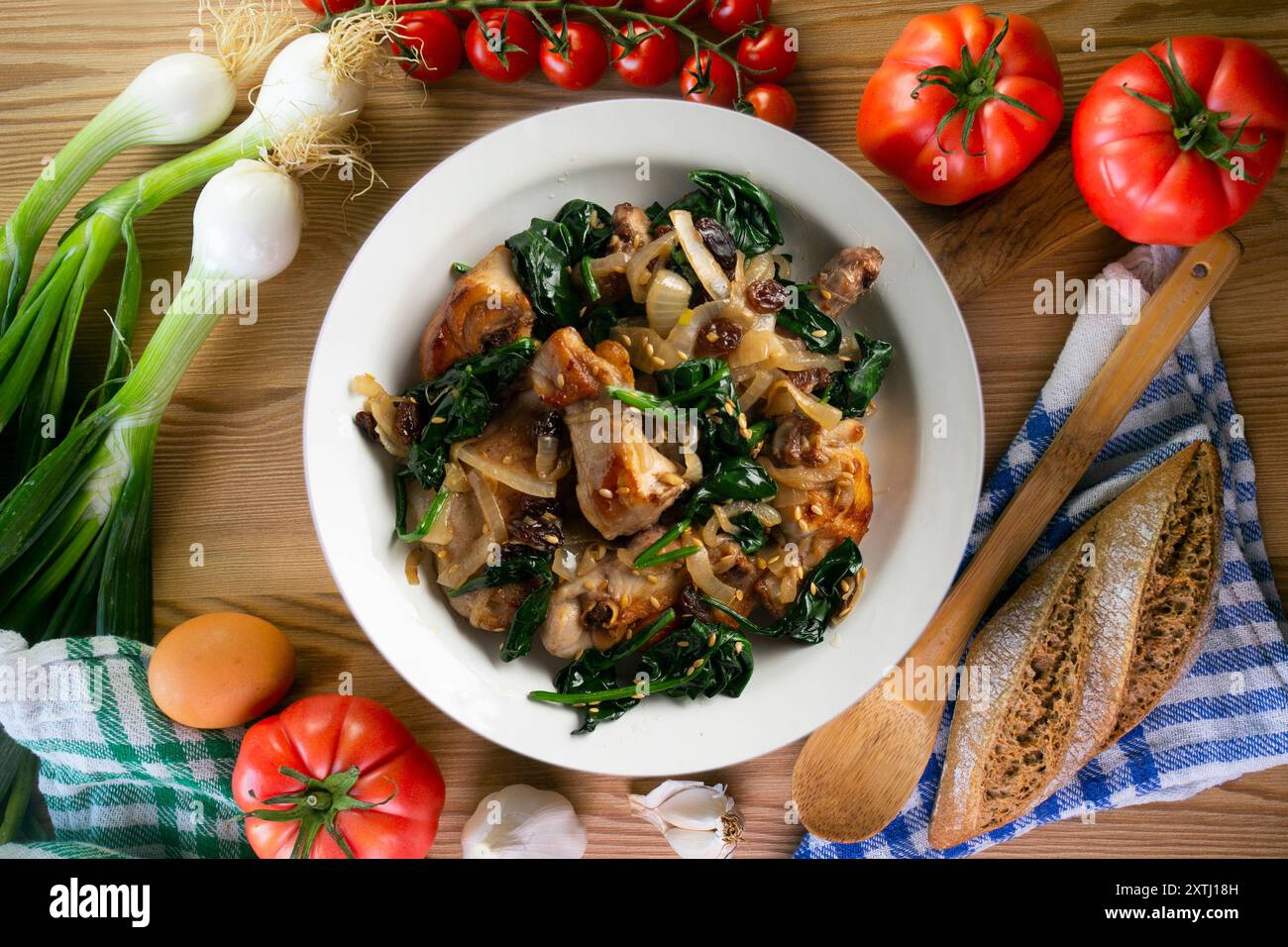 Delicious Rabbit stewed with spinach and raisins. Top view table Stock ...