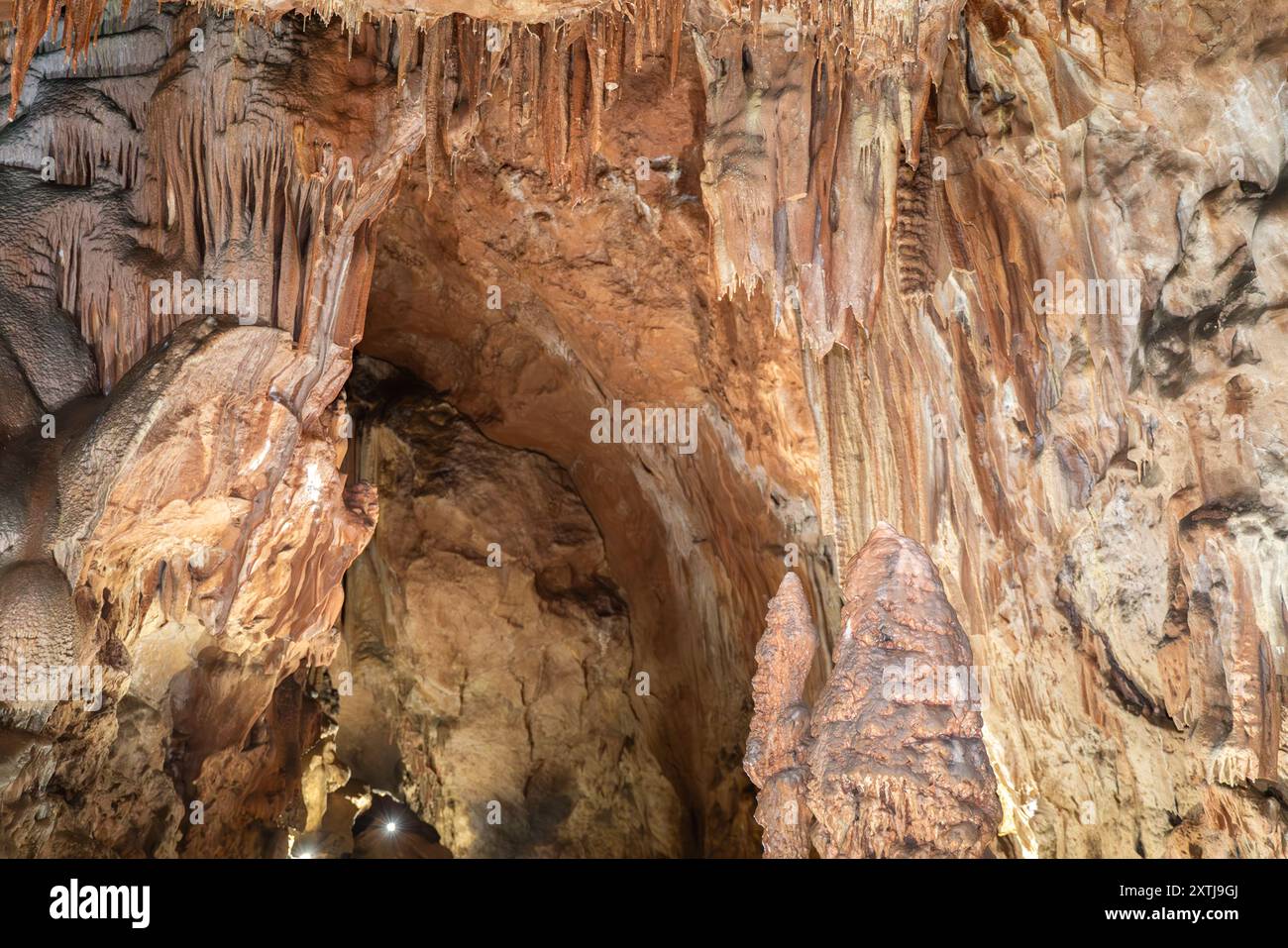 A cave with a large rock formation that looks like a giant mushroom ...