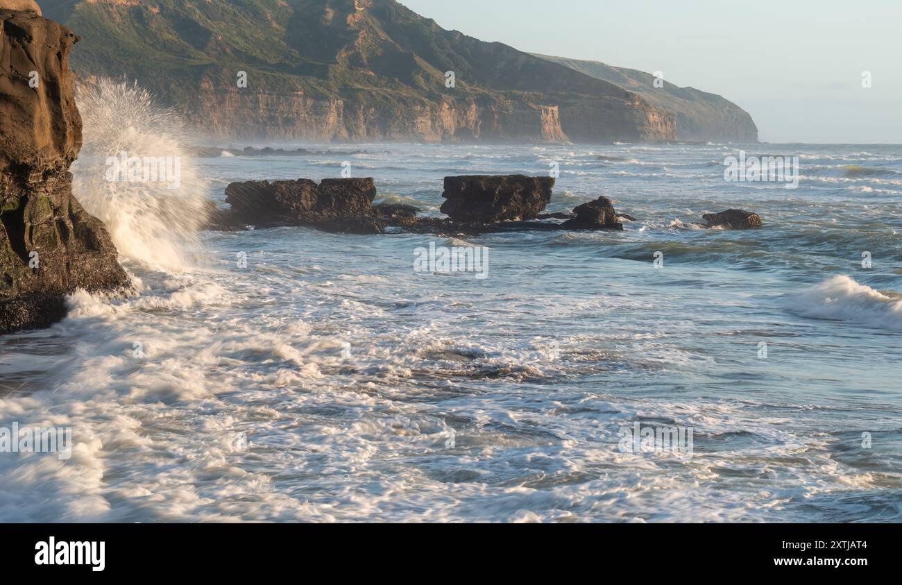 Waves crash on beach sunset hi-res stock photography and images - Alamy