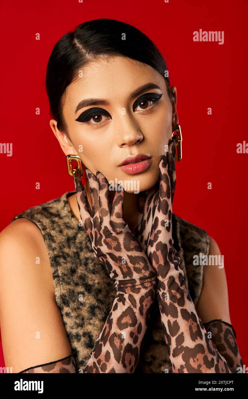 Woman in leopard print outfit with matching gloves poses with hands on ...