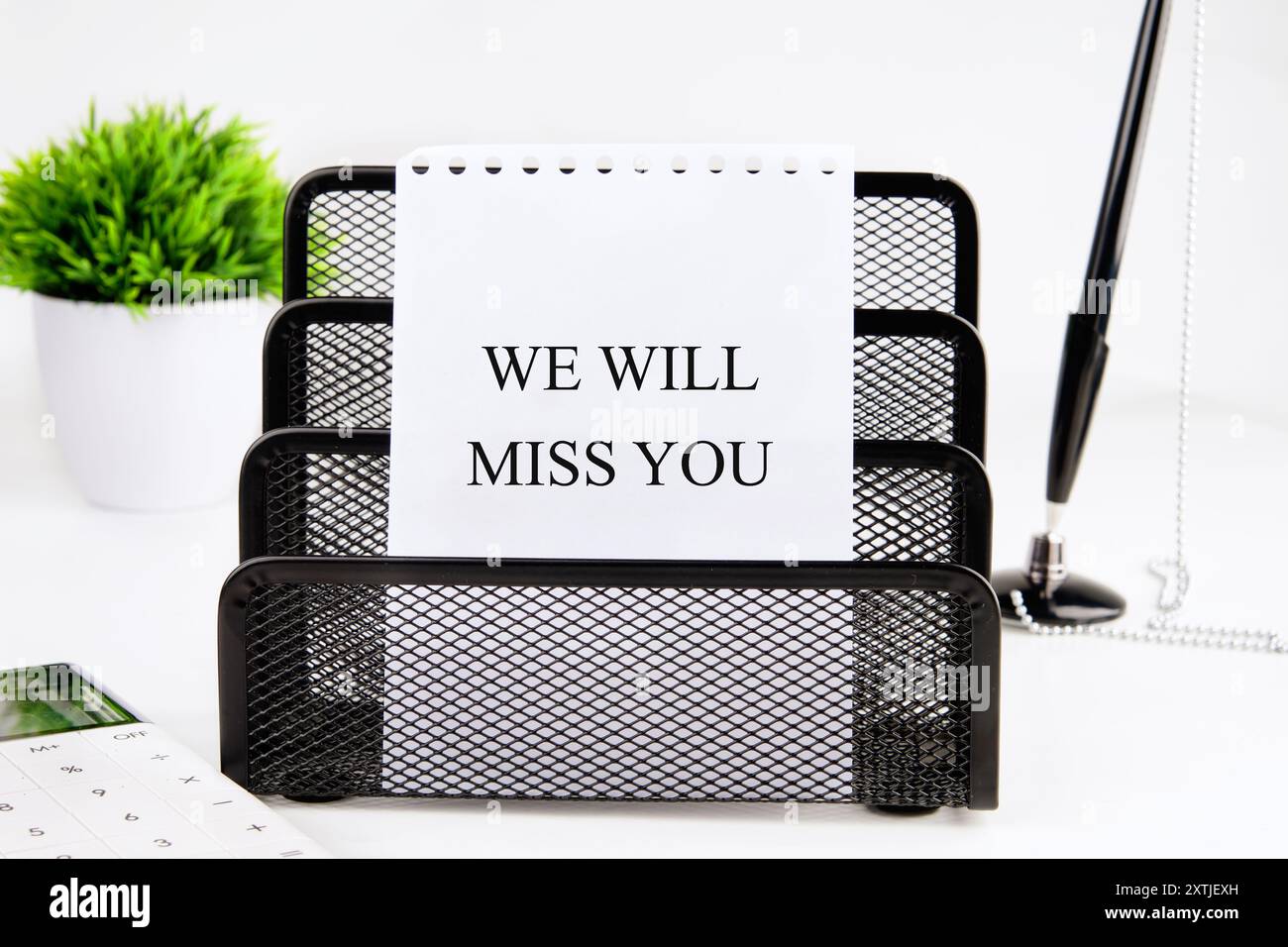 WE WILL MISS YOU written on a white sheet of paper in a stationery ...