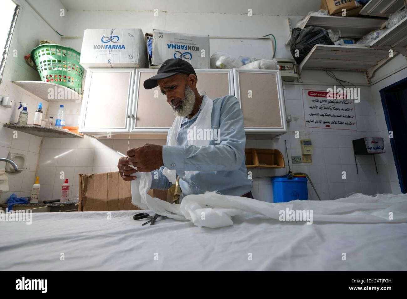 Palestinian morgue worker Nawaf al-Zuriei, a morgue worker prepares a ...