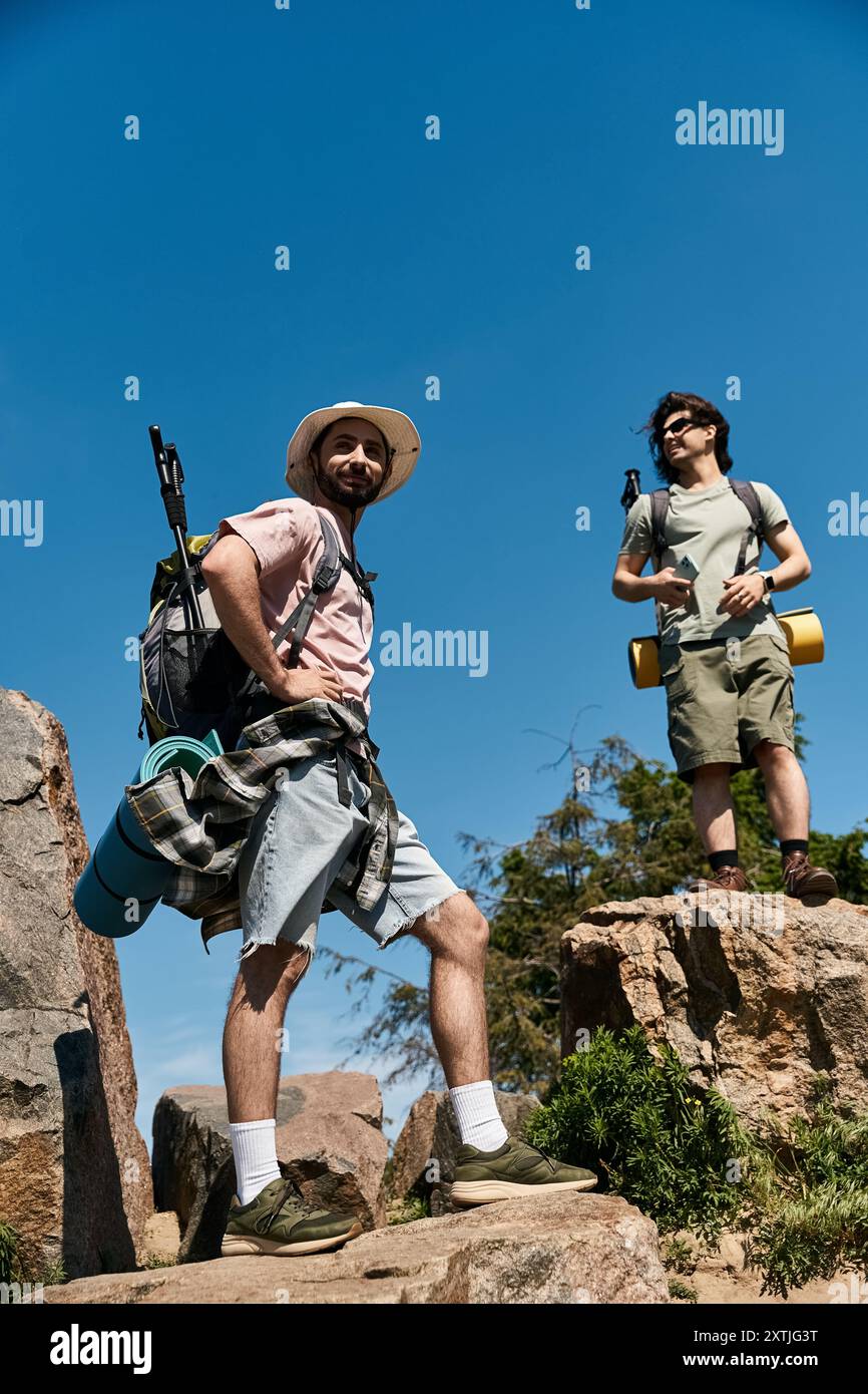 Two young men, a gay couple, enjoy a summer hiking adventure in the ...