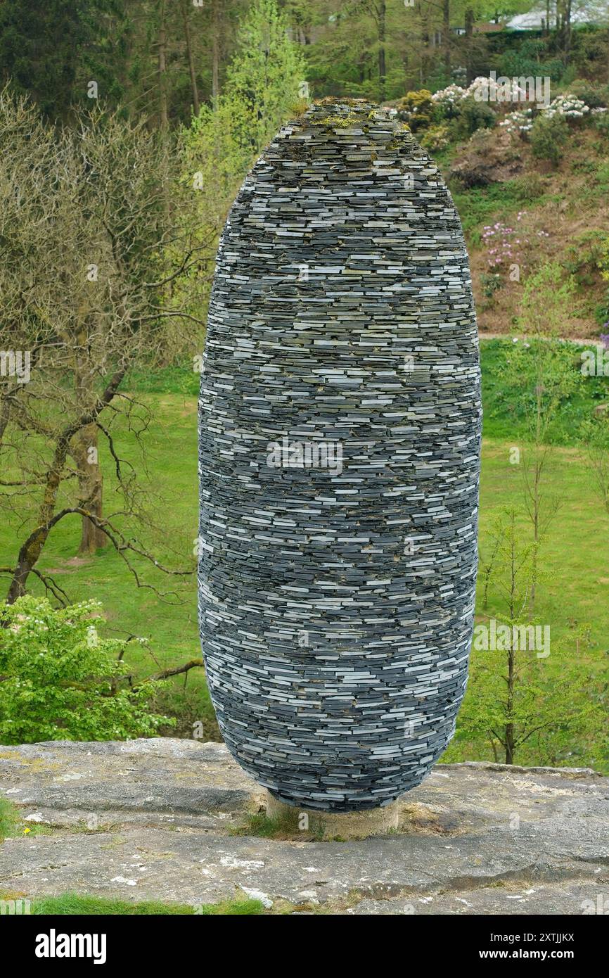 Striking contemporary sculpture crafted from layers of slate, standing ...