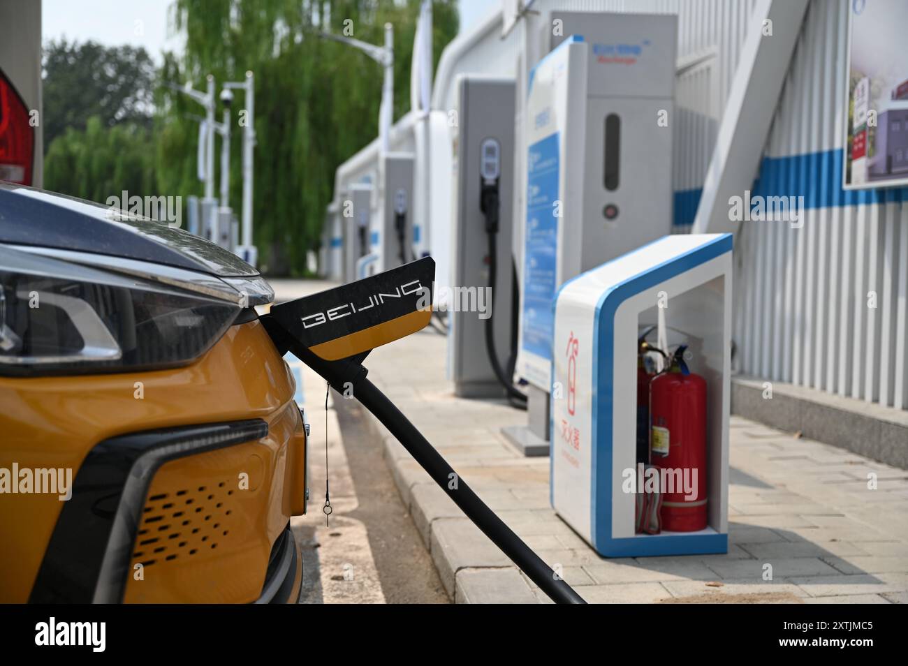 15 August 2024, China, Peking: A Beijing cab charges at a charging ...