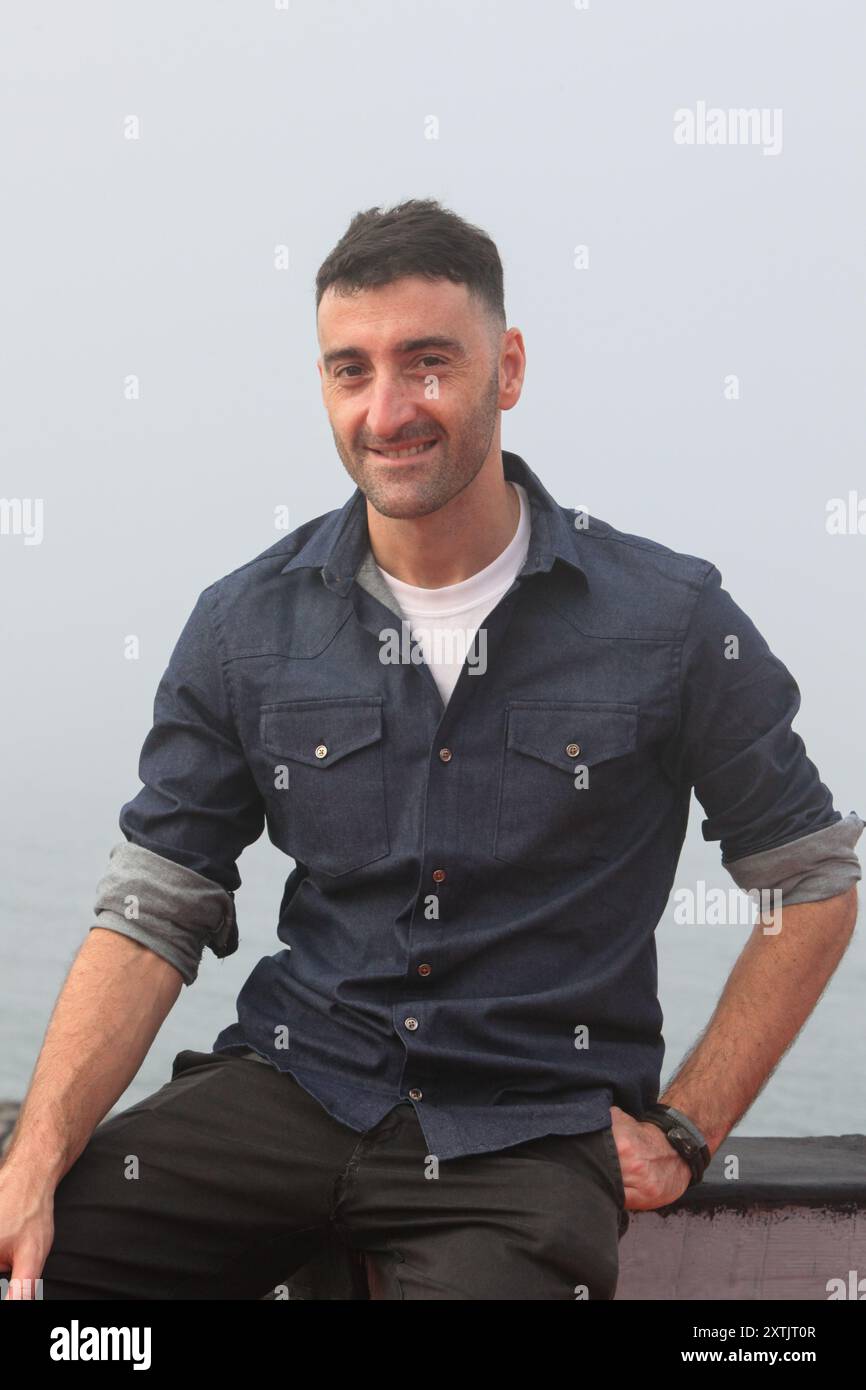 portrait of a handsome cheerful young latino man outdoors Stock Photo ...