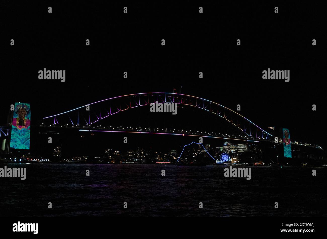 Sydney’s landmark of the Harbour Bridge lit up with coloured lazar ...