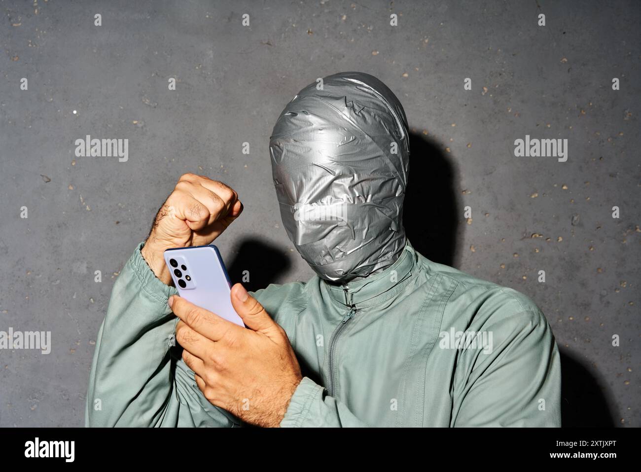 Mystery man with duct tape face types celebrating his success with ...