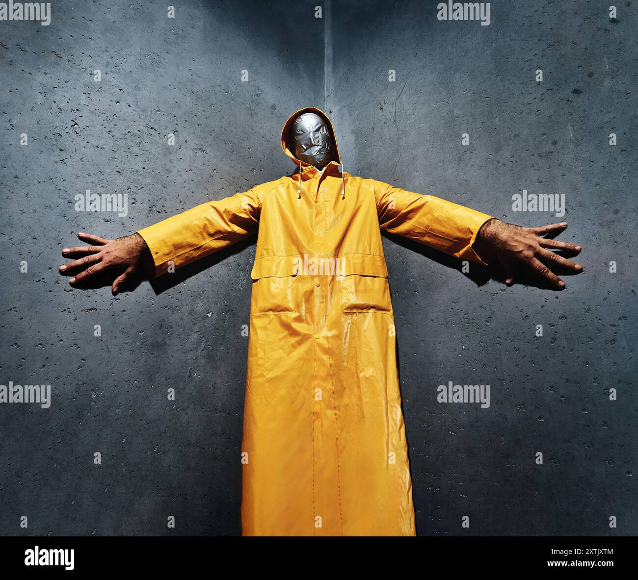 Giant scary man with duct tape face wrap in bright yellow raincoat ...