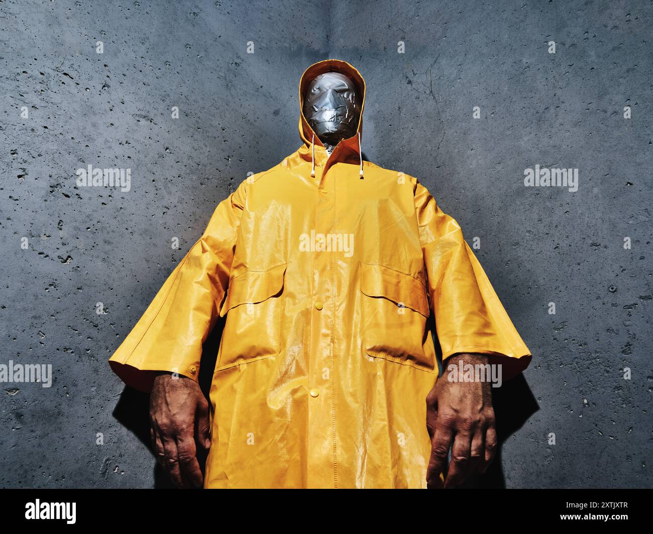 Giant scary man with duct tape face wrap in bright yellow raincoat ...