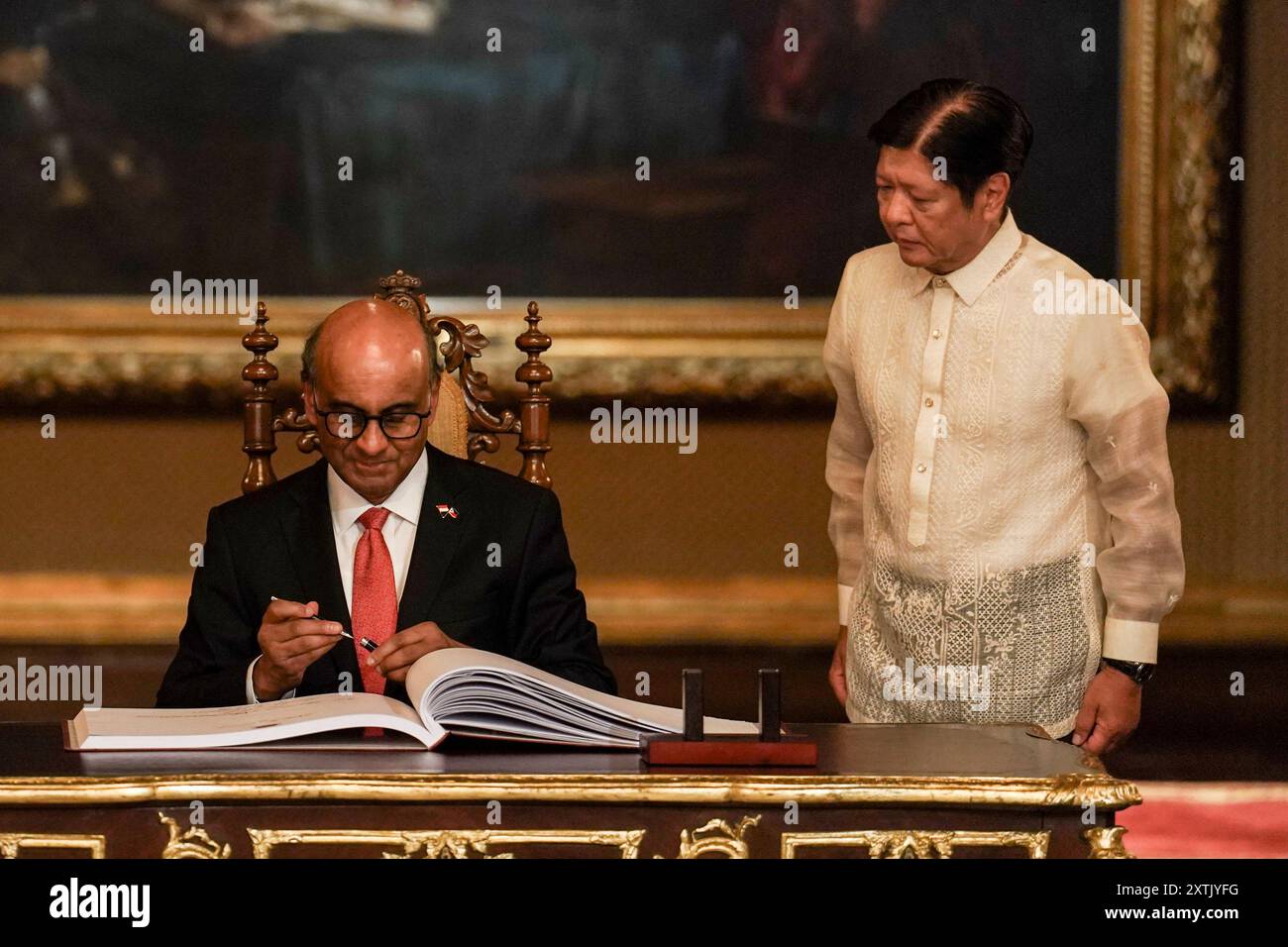 Singapore President Tharman Shanmugaratnam signs a guestbook during his ...