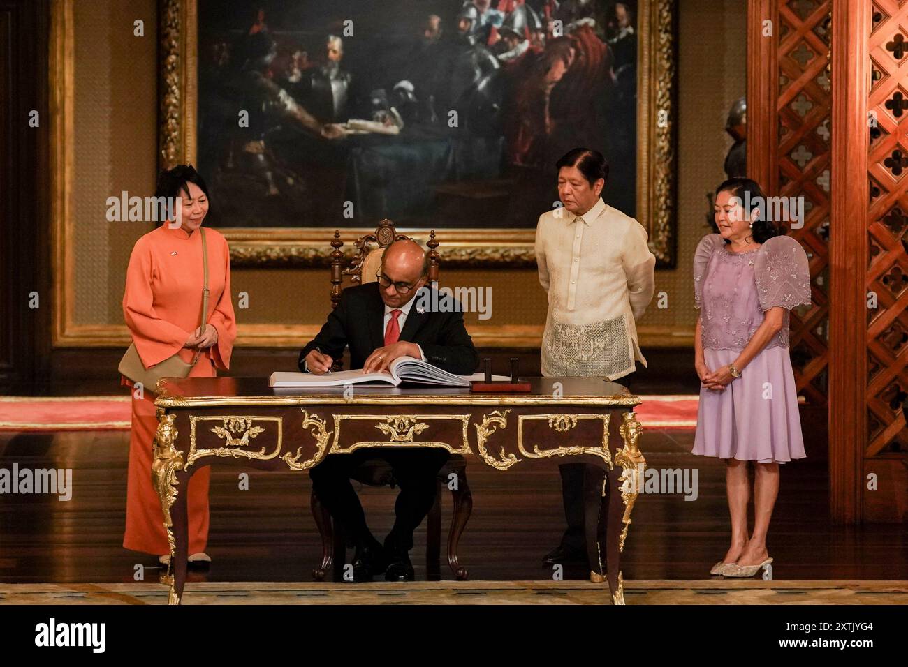Singapore President Tharman Shanmugaratnam signs a guestbook during his ...