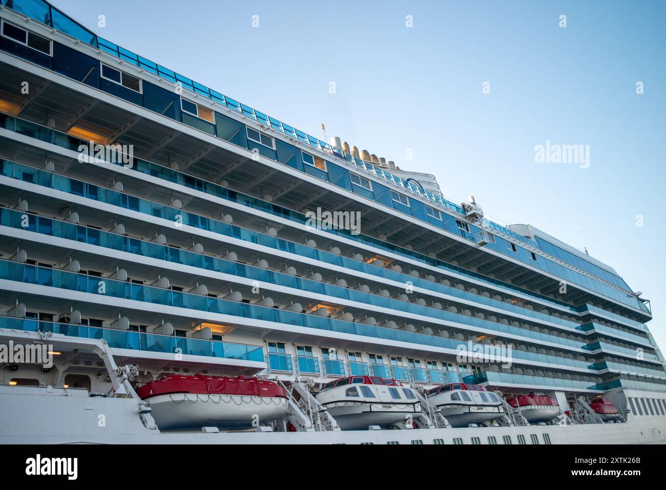 A detailed view of the windows and balconies of a large cruise ship ...