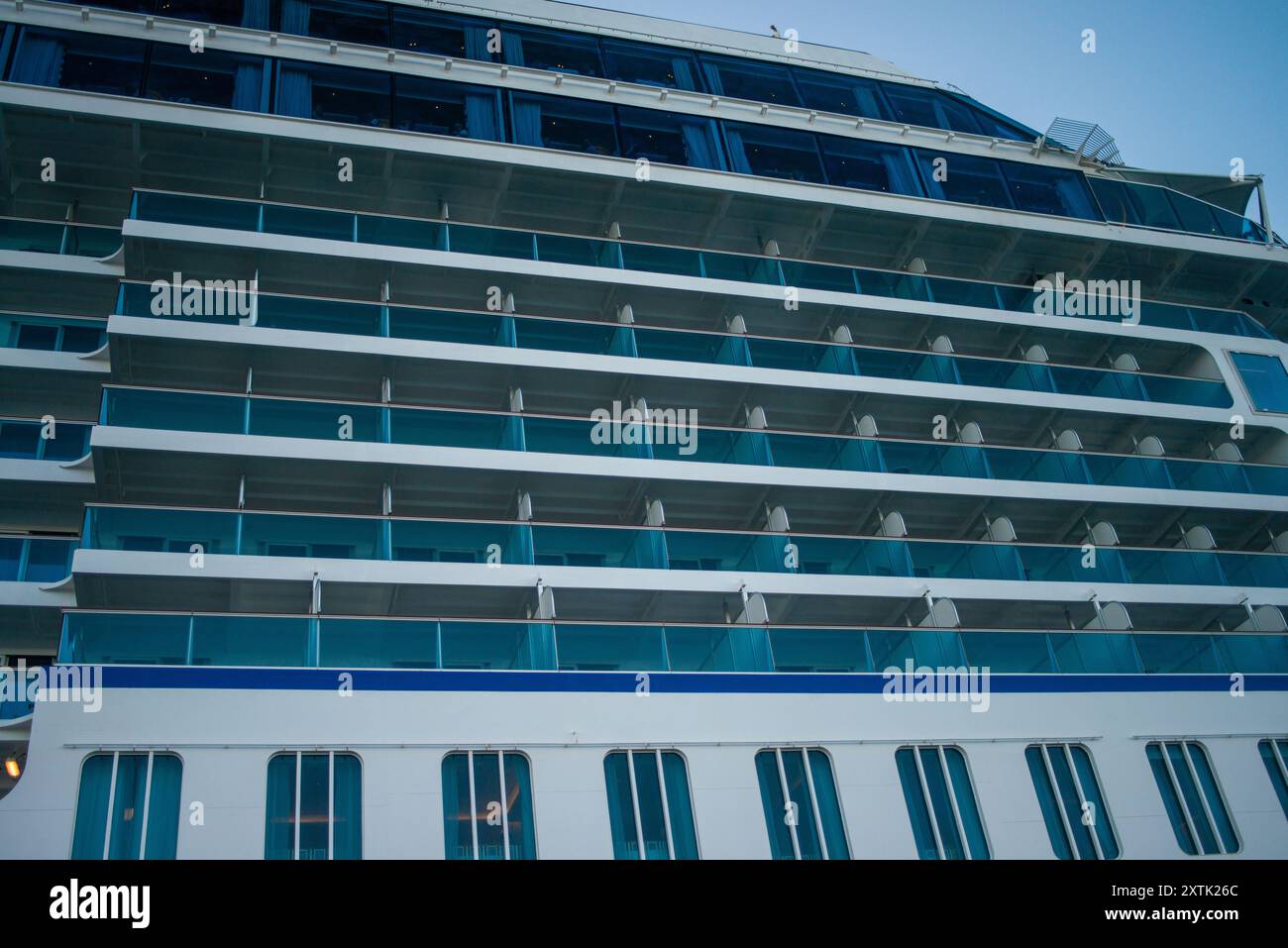 A detailed view of the windows and balconies of a large cruise ship ...