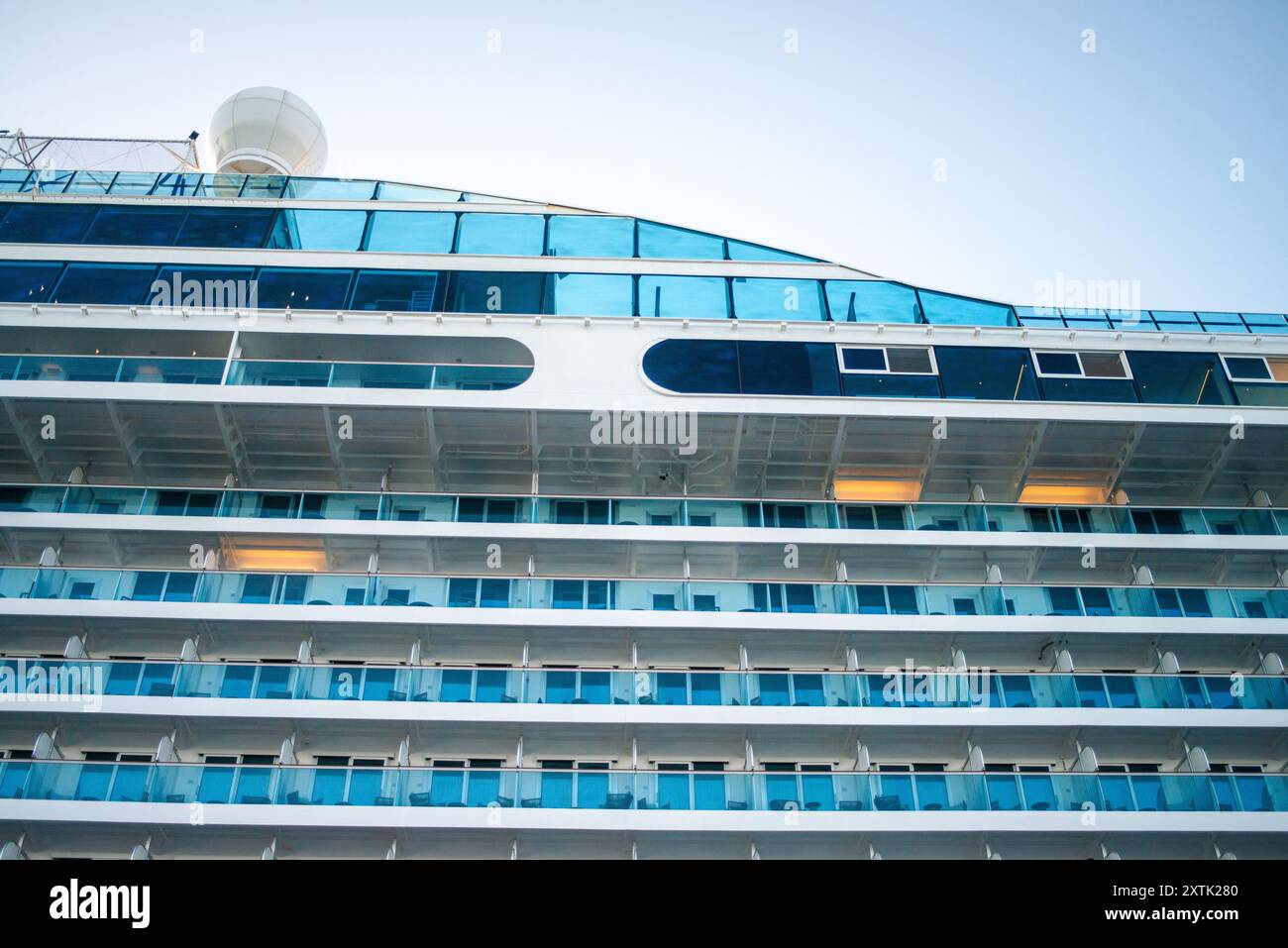 A detailed view of the windows and balconies of a large cruise ship ...