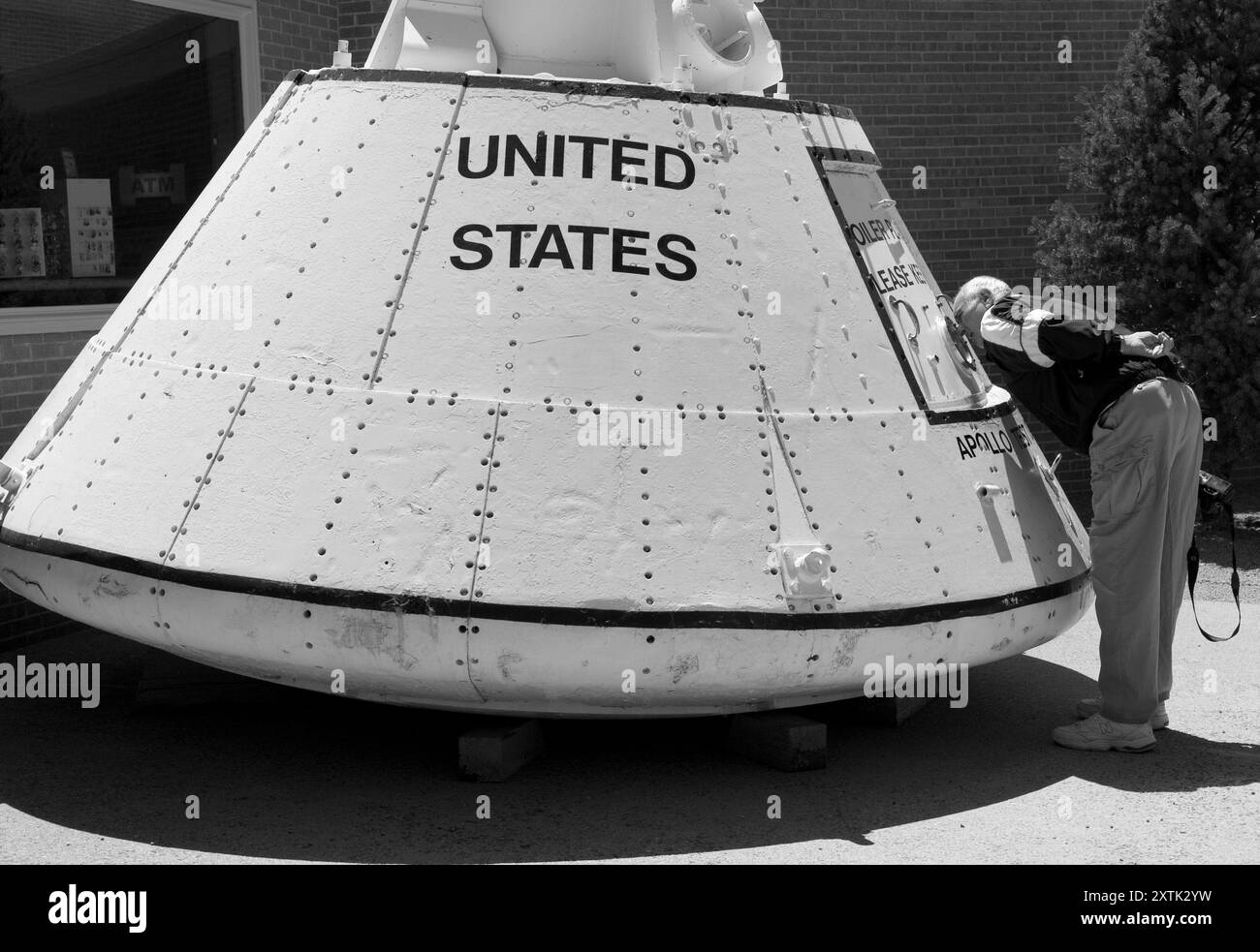 Caucasian man, aged 60 to 65, peers into the window of an Apollo test ...