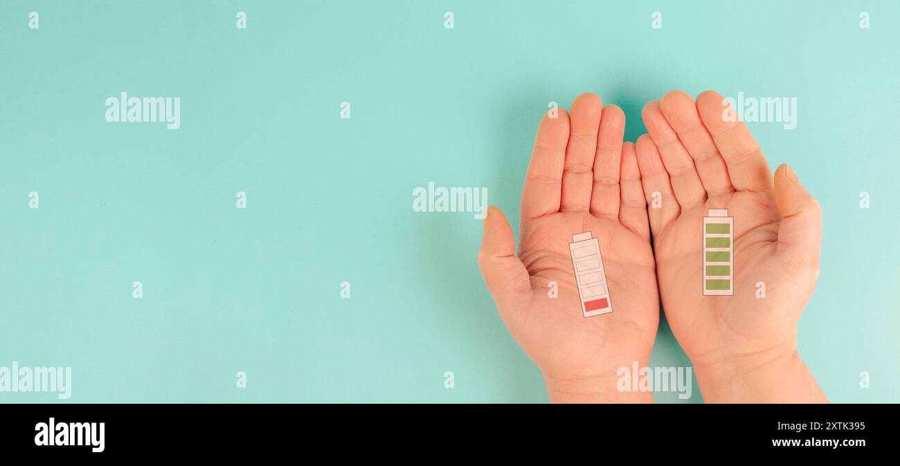 Hand with an empty and a full battery, exhausted by stress against ...