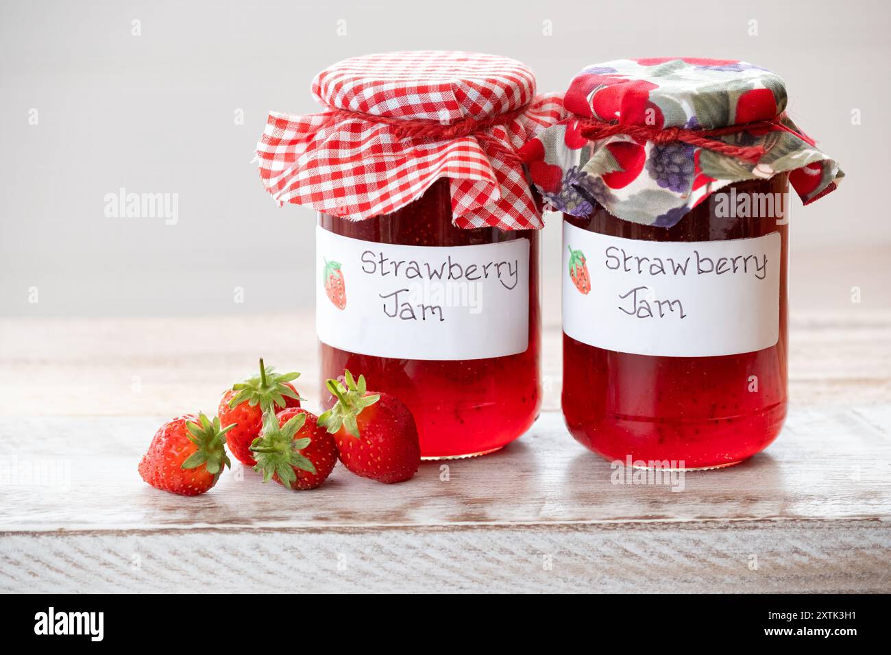 Jars of homemade Strawberry jam. The glass jars have clear handwritten ...