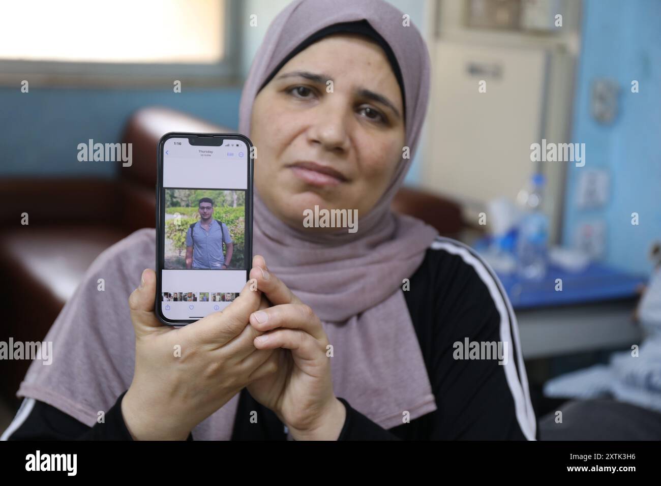 Baghdad, Iraq. 29th July, 2024. Reem Mohammed Abu Taha shows a picture ...
