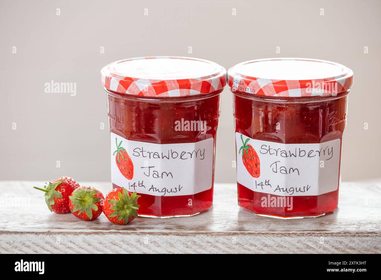 Jars of homemade Strawberry jam. The glass jars have clear handwritten ...