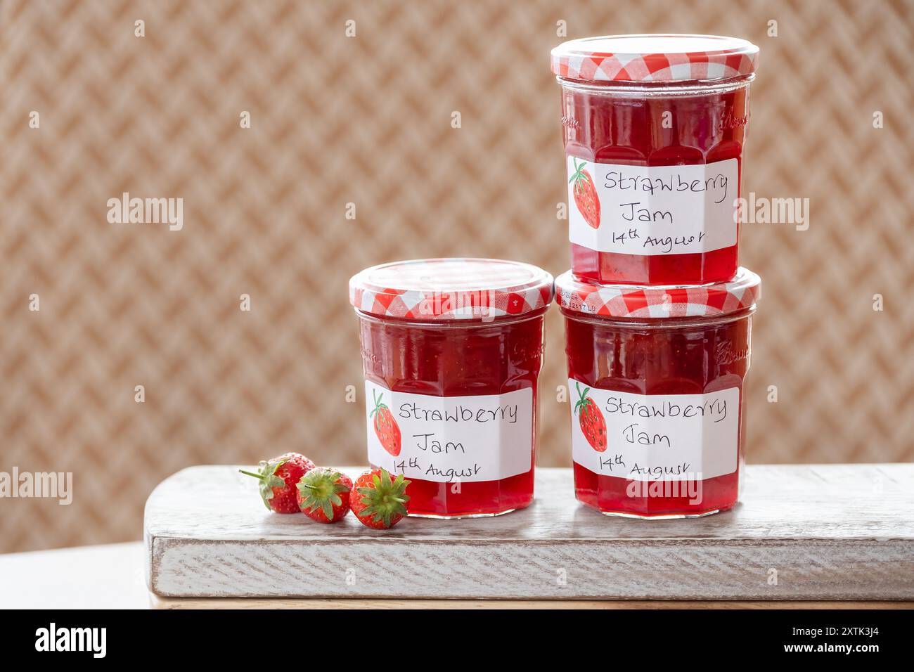 Jars of homemade Strawberry jam. The glass jars have clear handwritten ...