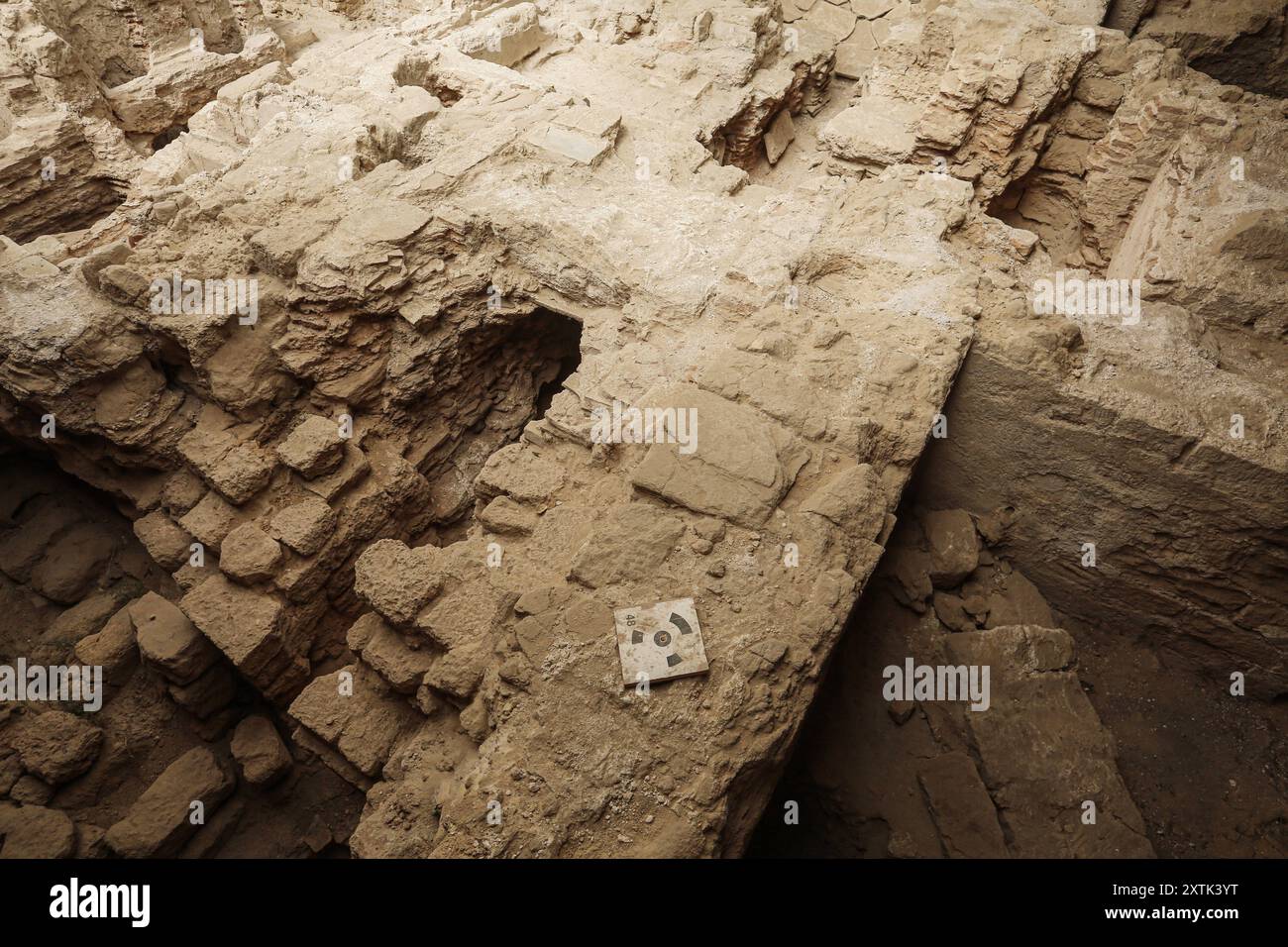 People stand on a platform overlooking ruins at the archaeological site ...