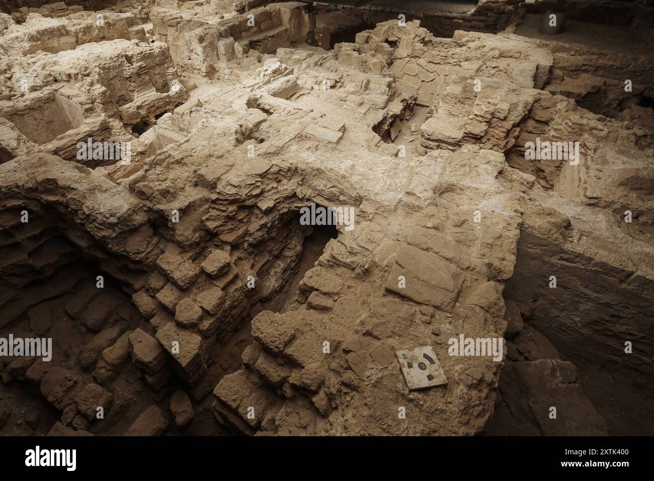 People stand on a platform overlooking ruins at the archaeological site ...