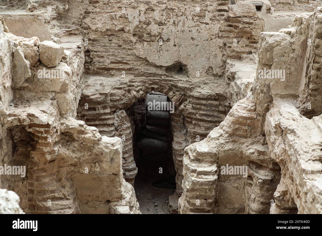 People stand on a platform overlooking ruins at the archaeological site ...