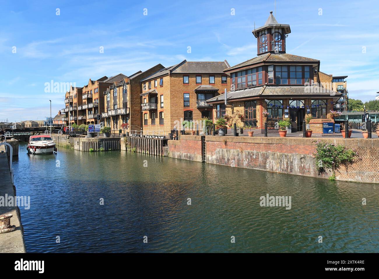 A boat enters London's Limehouse Basin through the lock from the River Thames. The Victorian ...
