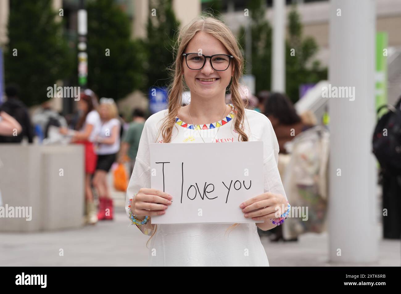 A fan with a sign referencing Taylor Swift's You Belong With Me music ...