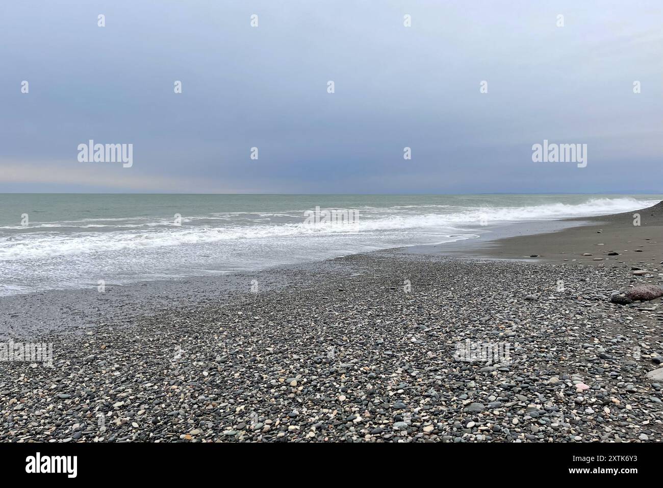Cold sea and beach with black sand and stones, nature background Stock ...