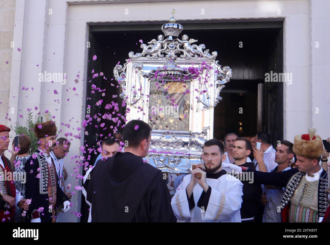 Sinj, Croatia. 15th Aug, 2024. Roman Catholic priests carry The ...