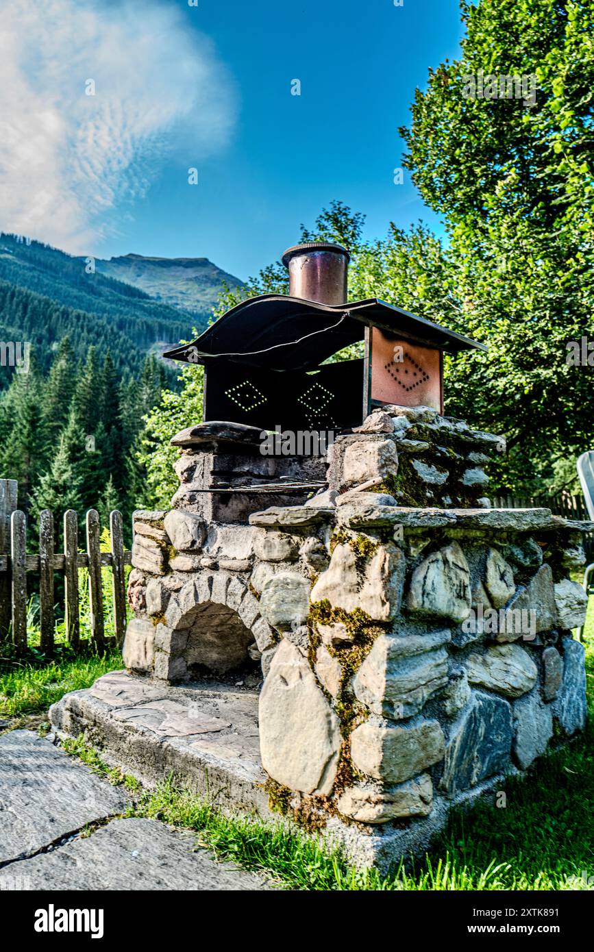 Outdoor fireplace with stone grill Stock Photo - Alamy