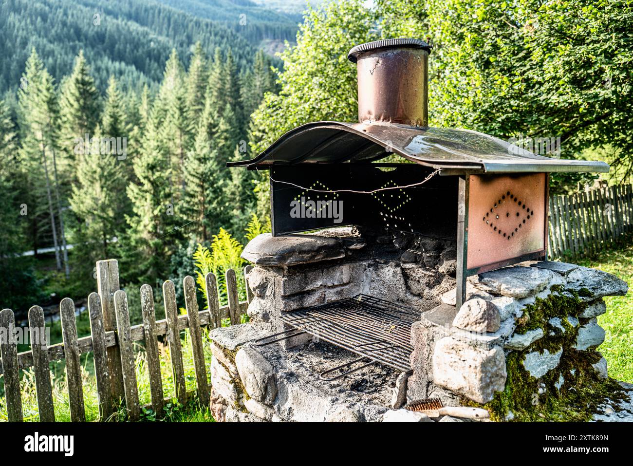 Outdoor fireplace with stone grill Stock Photo - Alamy