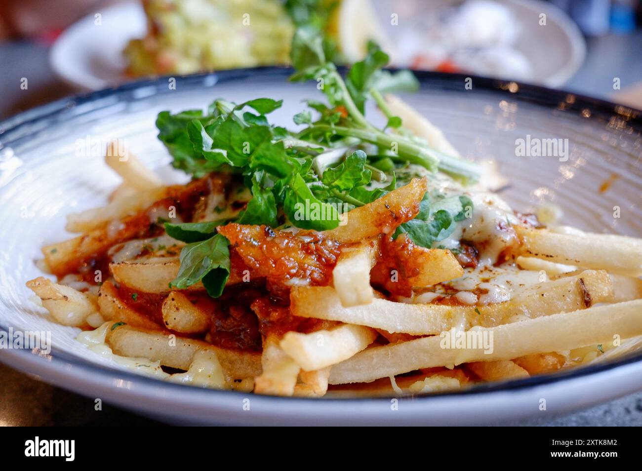 Delicious Fried Fries with Meted Cheese Stock Photo - Alamy
