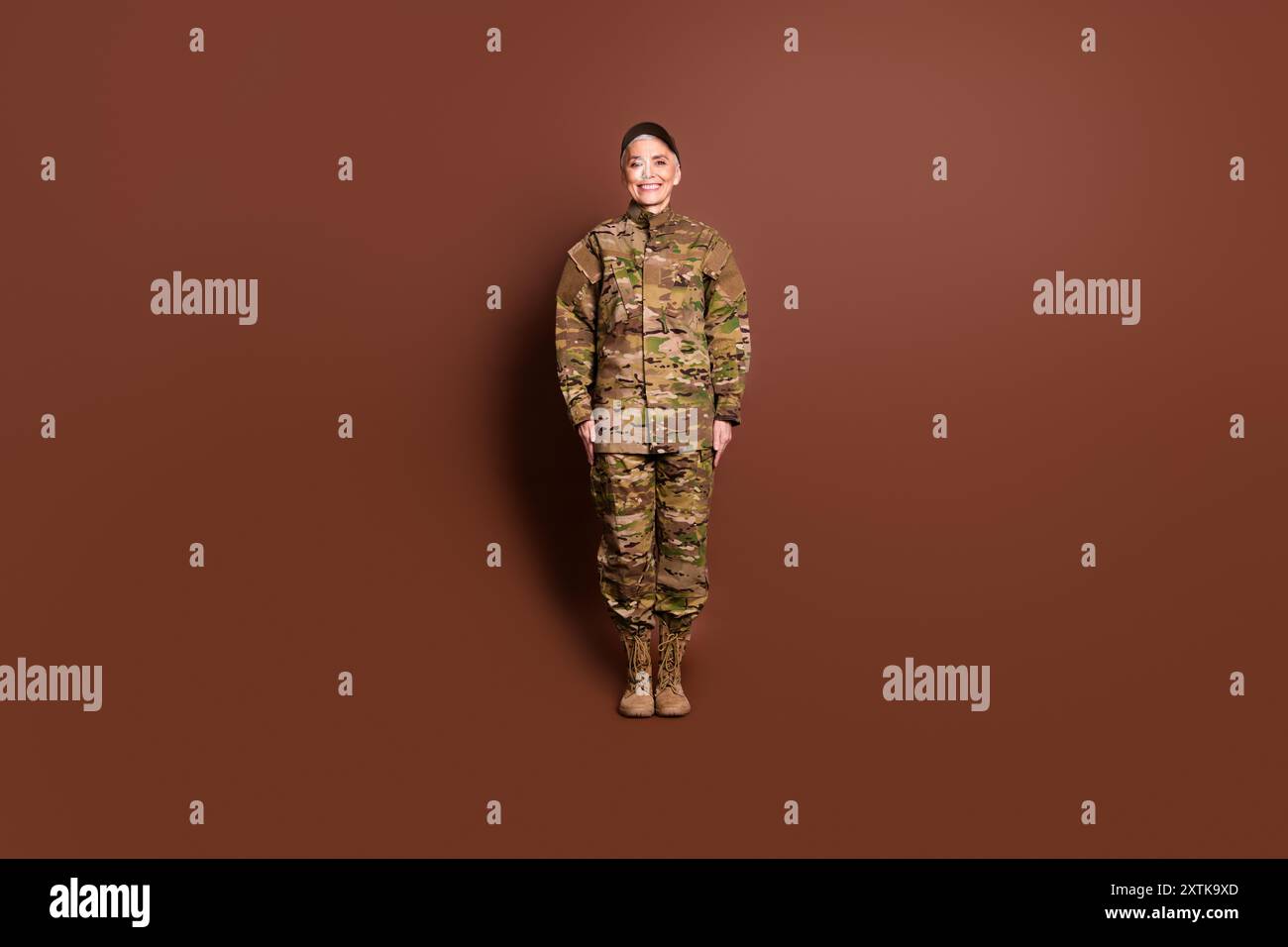 Full length photo of pensioner lady professional officer stand armed ...