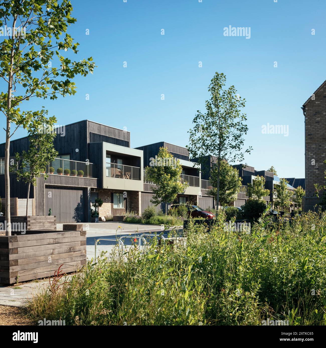 Street view with garages and balcony, railing and cladding detail with ...