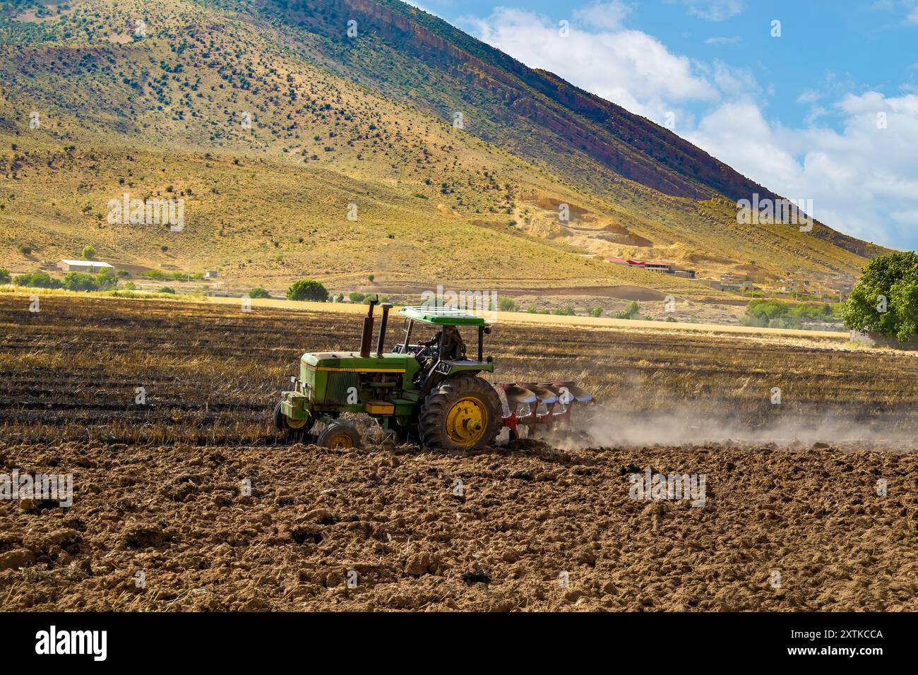 Tractor working on agricultural land,shiraz,iran Stock Photo - Alamy