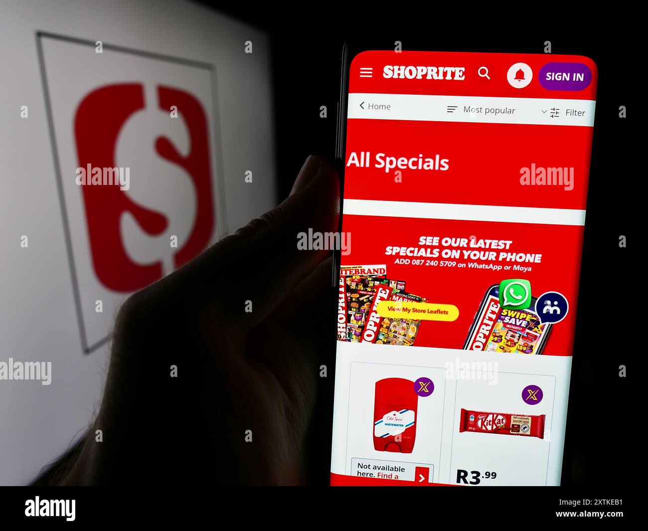 Person holding smartphone with webpage of South African supermarket ...