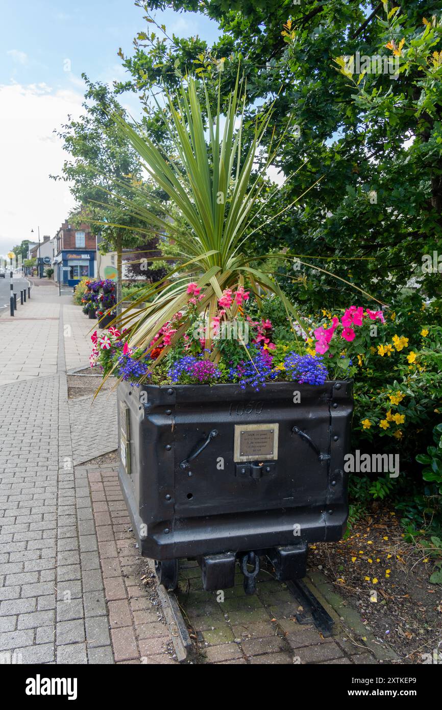Sacriston, County Durham, UK. Coal tub floral display in the town - a ...