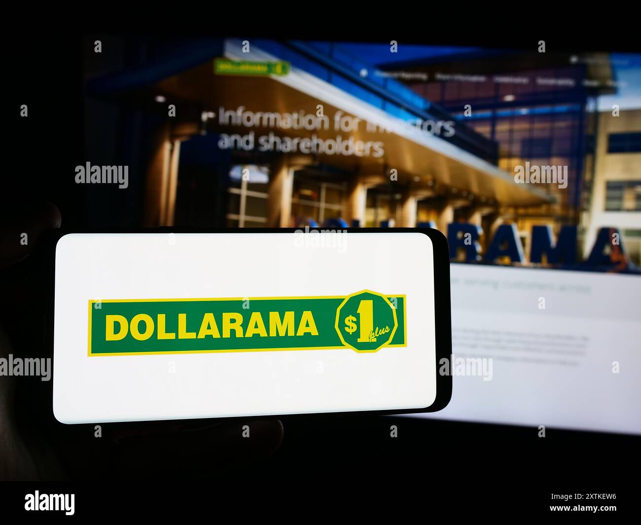 Person holding smartphone with logo of Canadian dollar store company ...