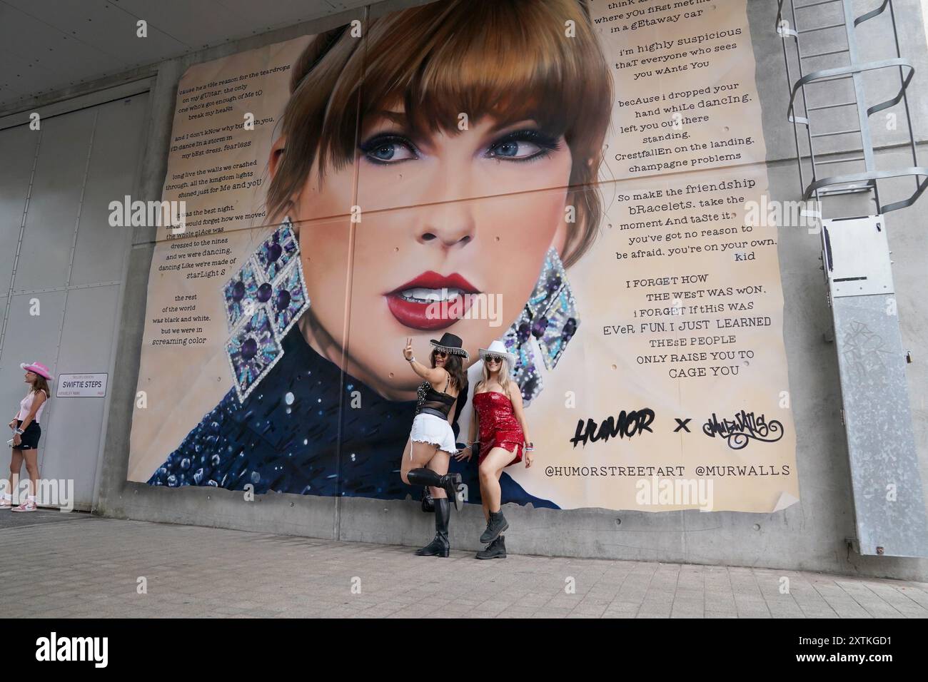 Fans pose in front of a mural of Taylor Swift at Wembley Stadium in ...