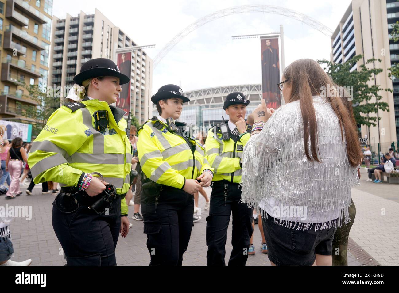Police officers display their friendship bracelets while speaking to a ...