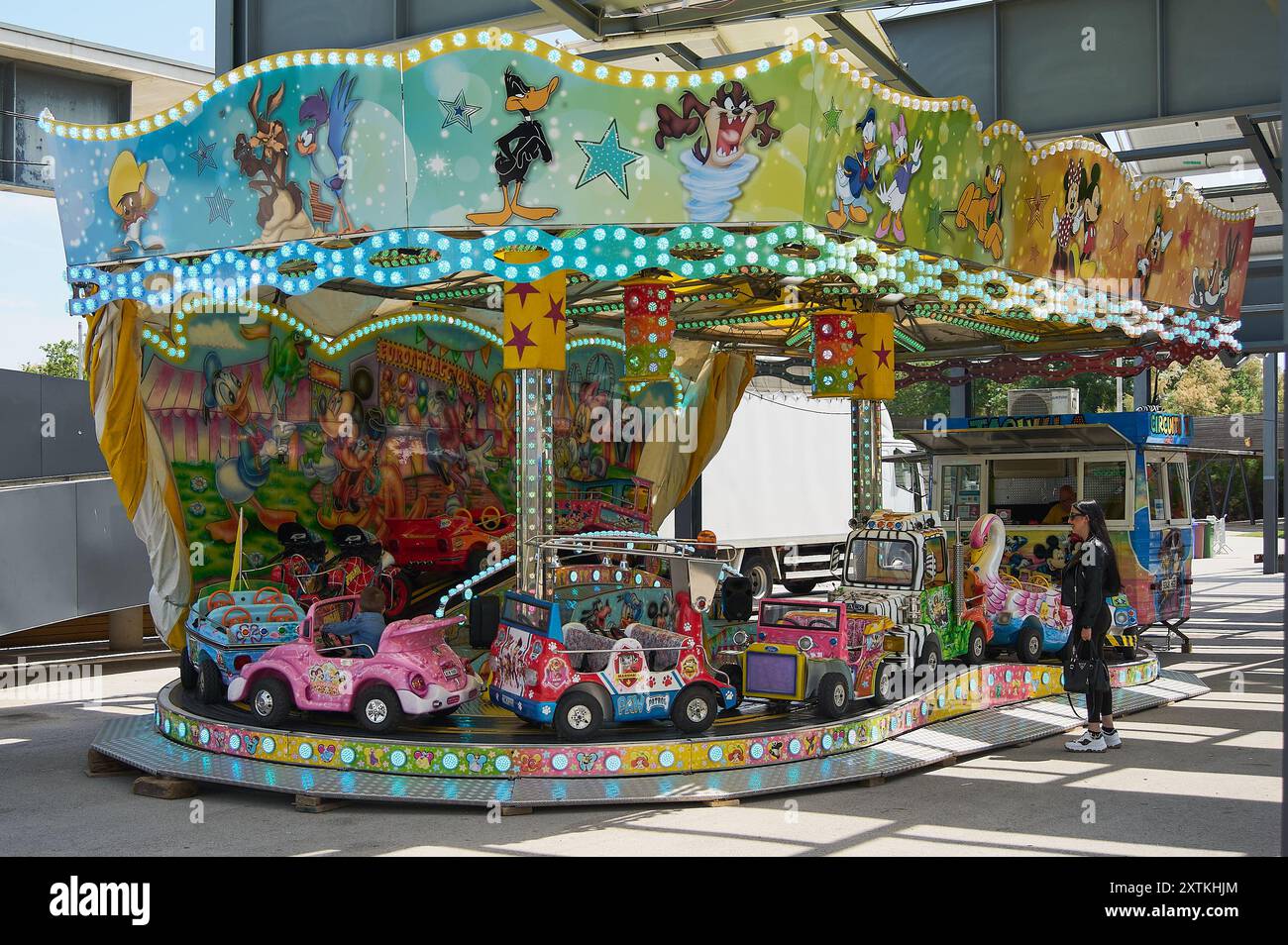 Viladecasn, SPAIN - AUGUST 15, 2024: Fairground carousel with cars and ...