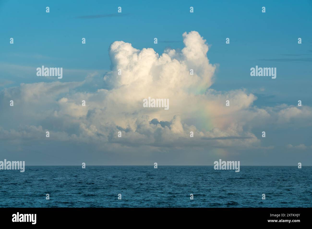 On a sunny afternoon, towering cumulus clouds cast huge shadows across the Pacific Ocean. The ...